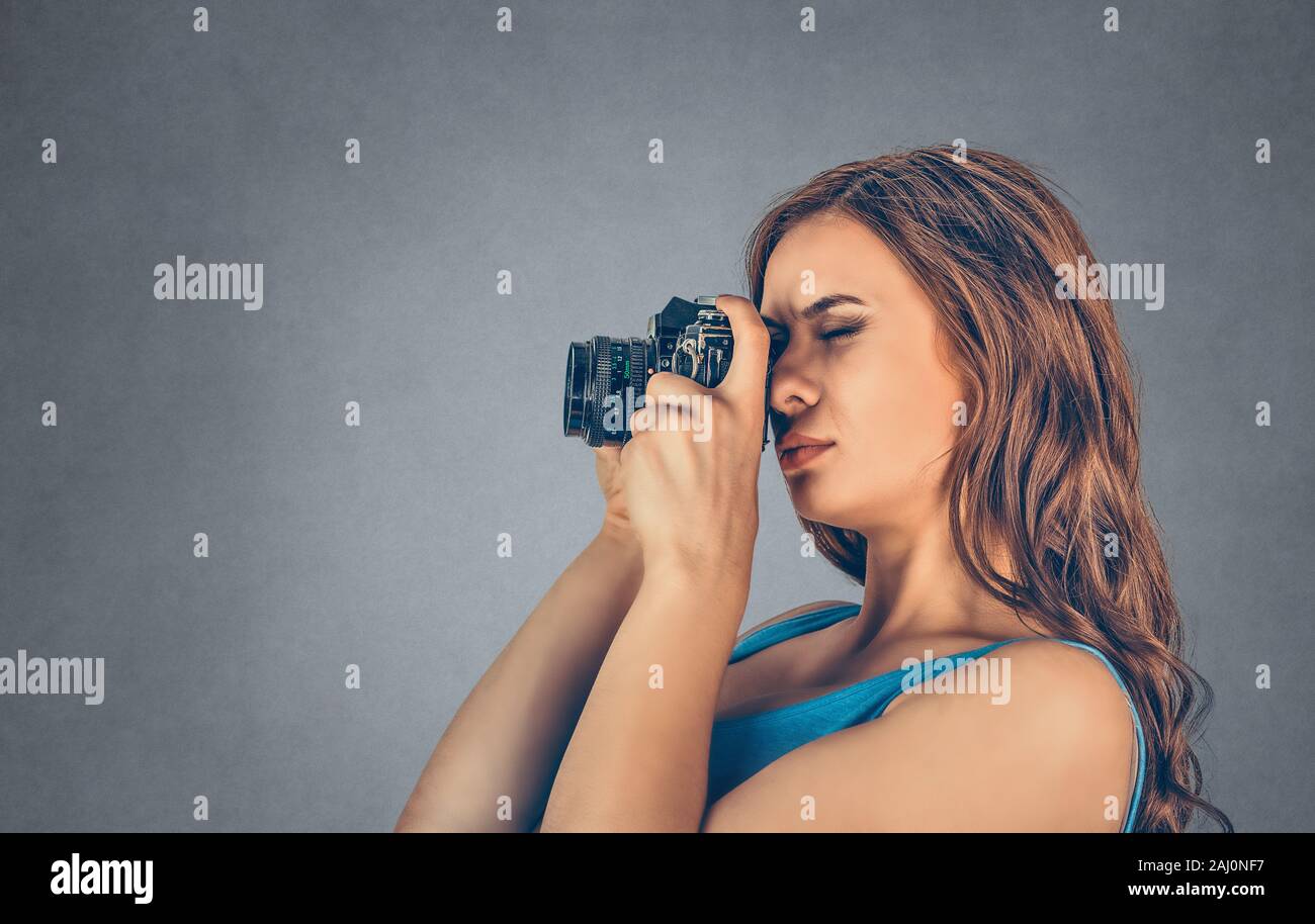 Side profile young woman taking pictures with professional camera ...