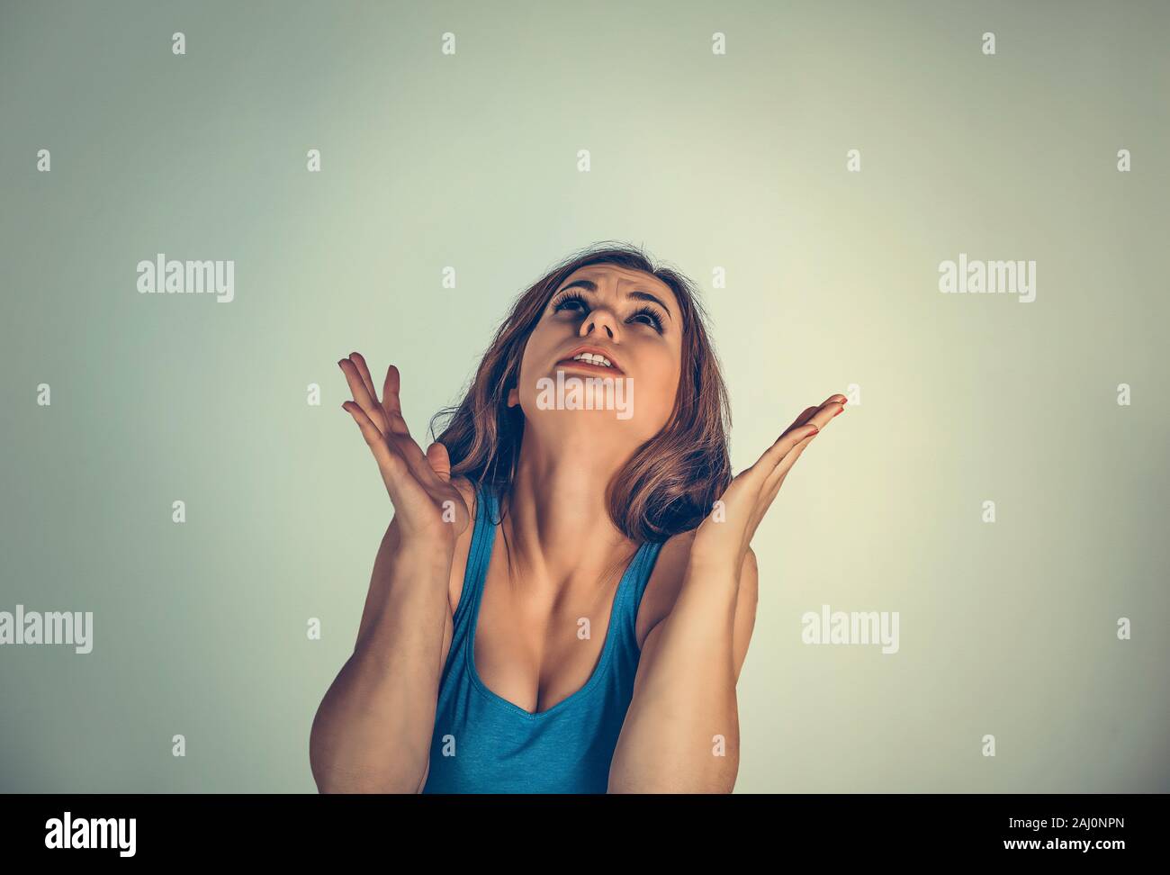 Furious stressed woman screaming looking up in frustration, hands in ...