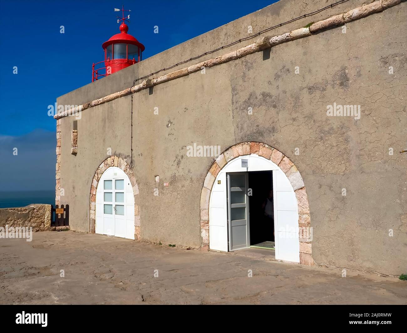 Famous lighthouse building in Nazare in Portugal surrounded by Atlantic ...