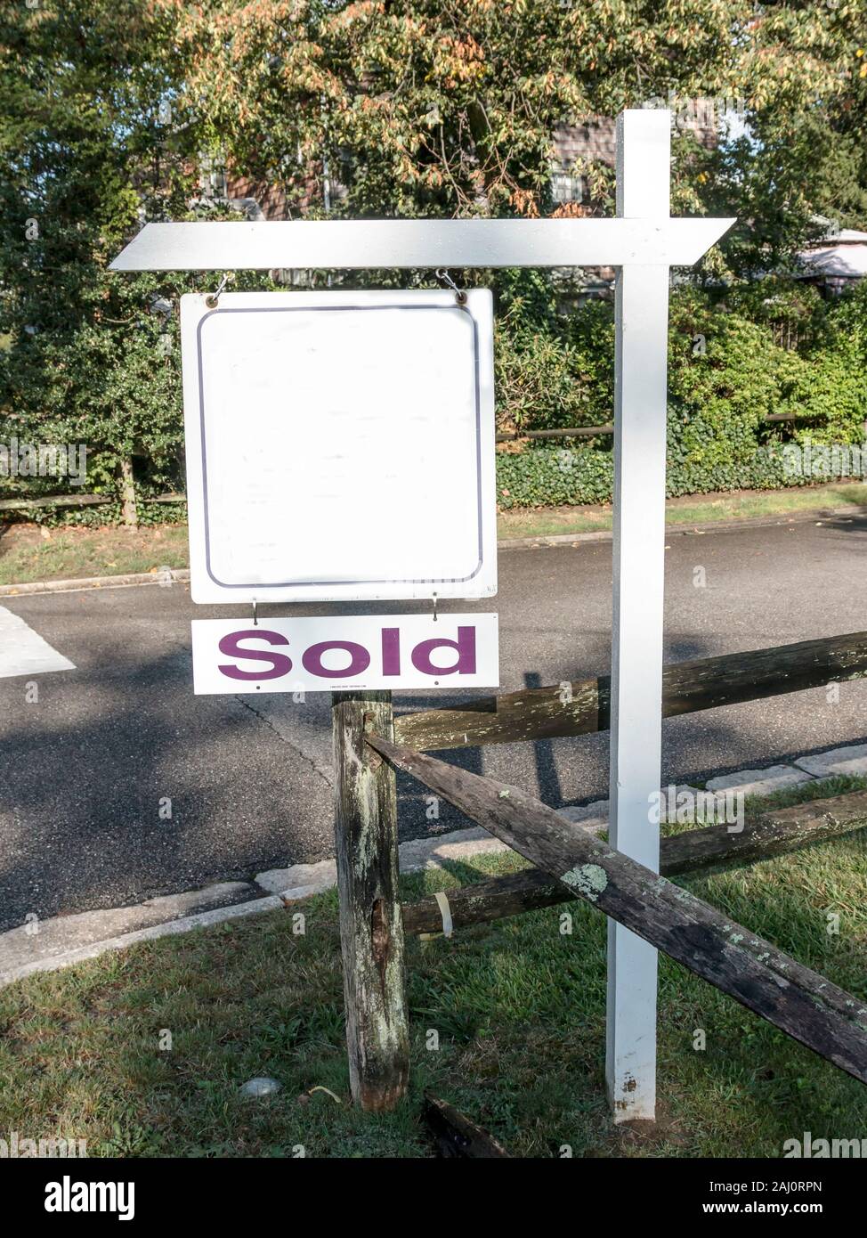 A real estate sign is placed on a corner to advertise a house was for ...
