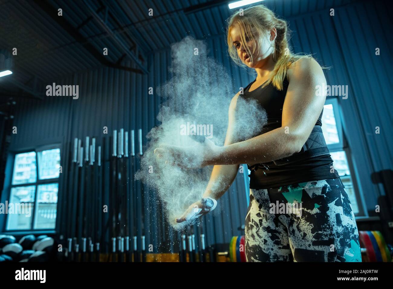 Caucasian teenage girl practicing in weightlifting in gym. Female ...