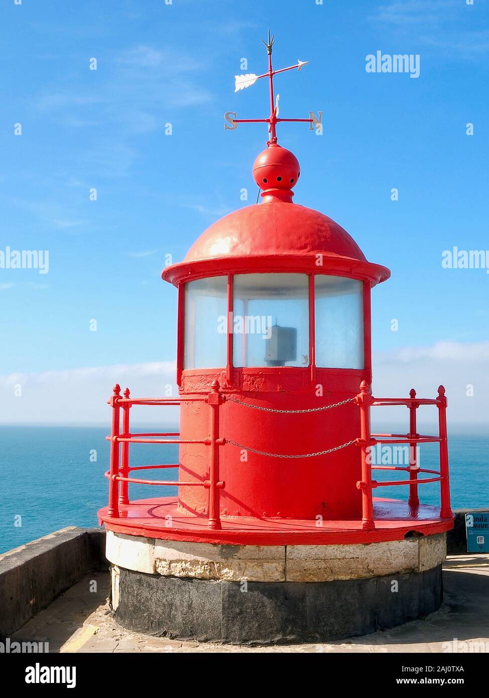 Famous lighthouse in Nazare in Portugal surrounded by Atlantic ocean ...