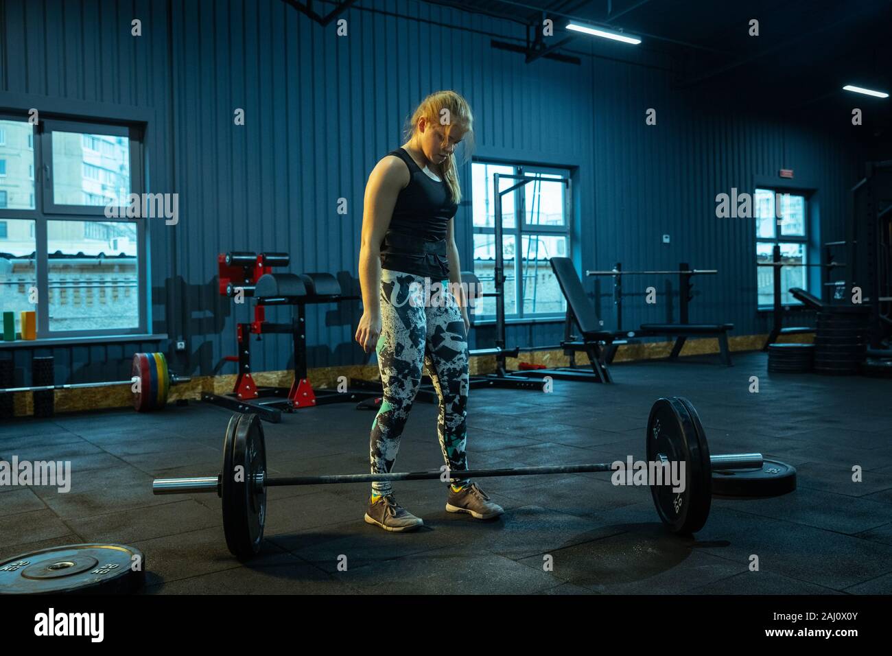 Caucasian teenage girl practicing in weightlifting in gym. Female ...