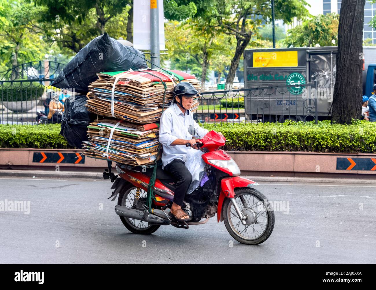 Vietnamese man riding motorcycle laden with cardboard Ho Chi Minh City ...