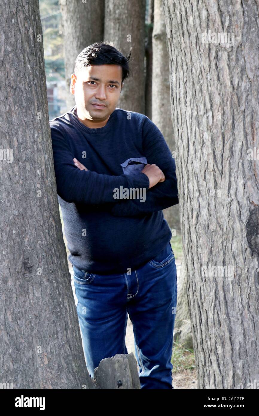 Man standing between two trees hi-res stock photography and images - Alamy