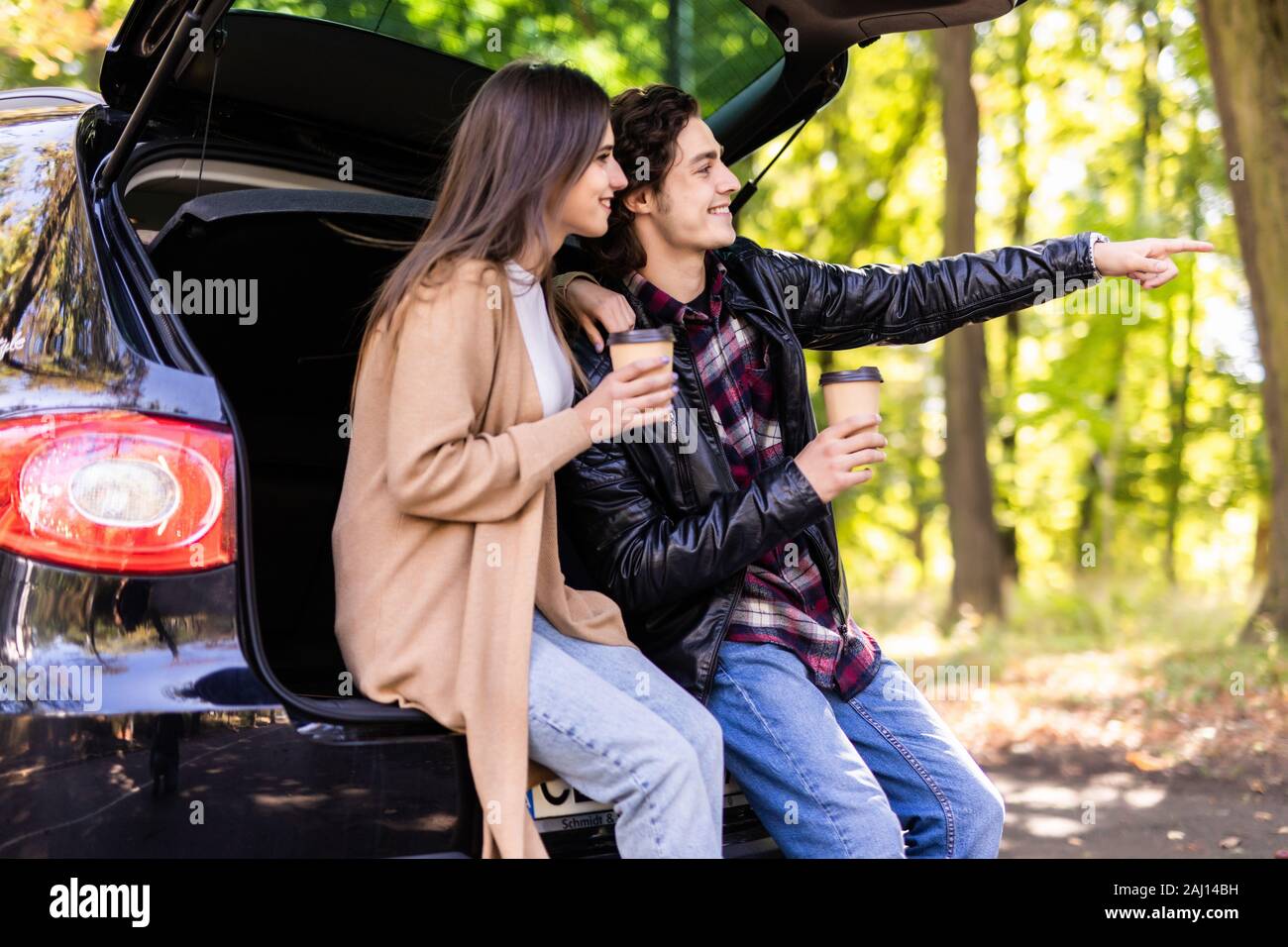 Couple sitting in boot of car hi-res stock photography and images - Alamy