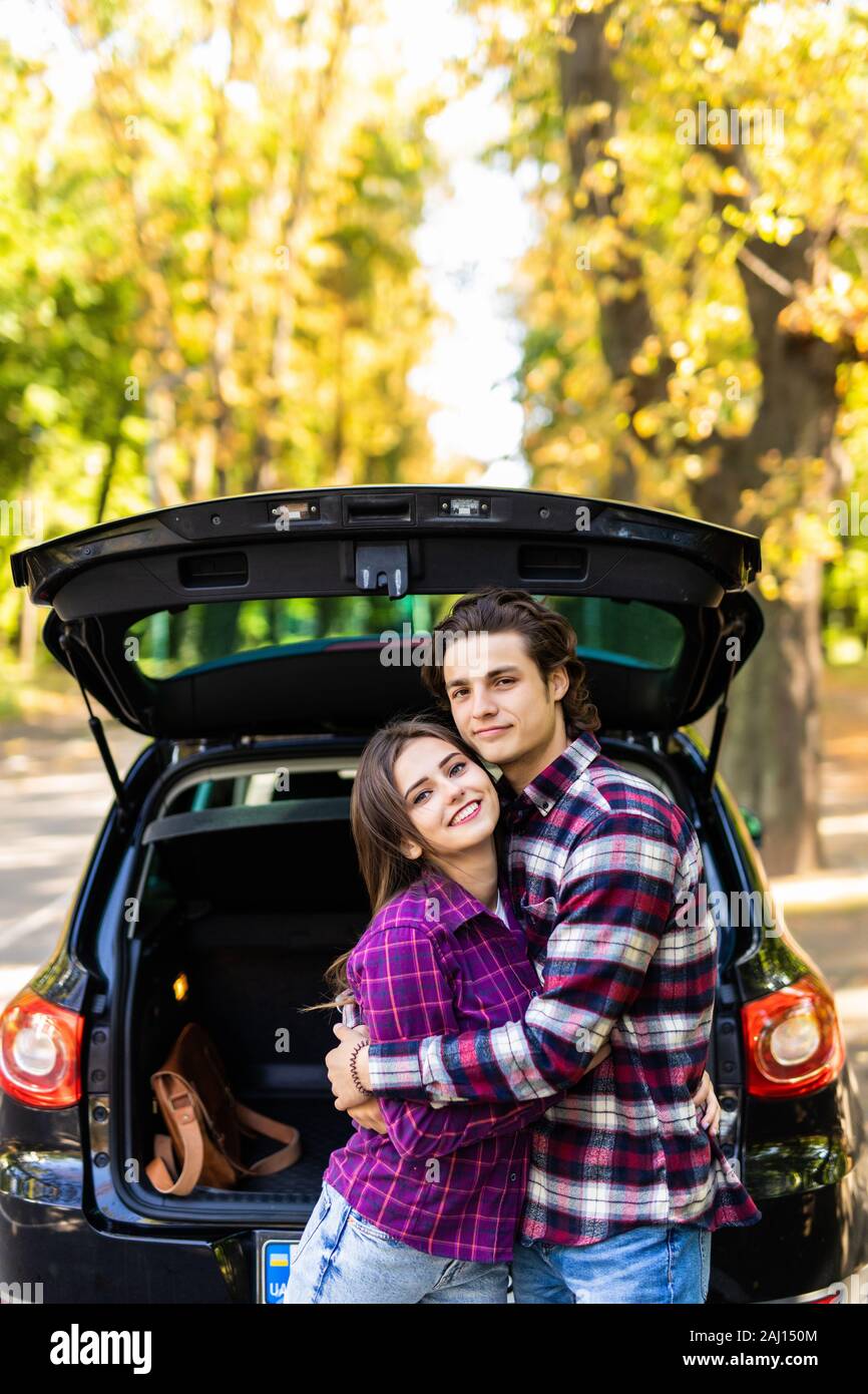 Young man and woman hugging and touching each other while sitting in ...