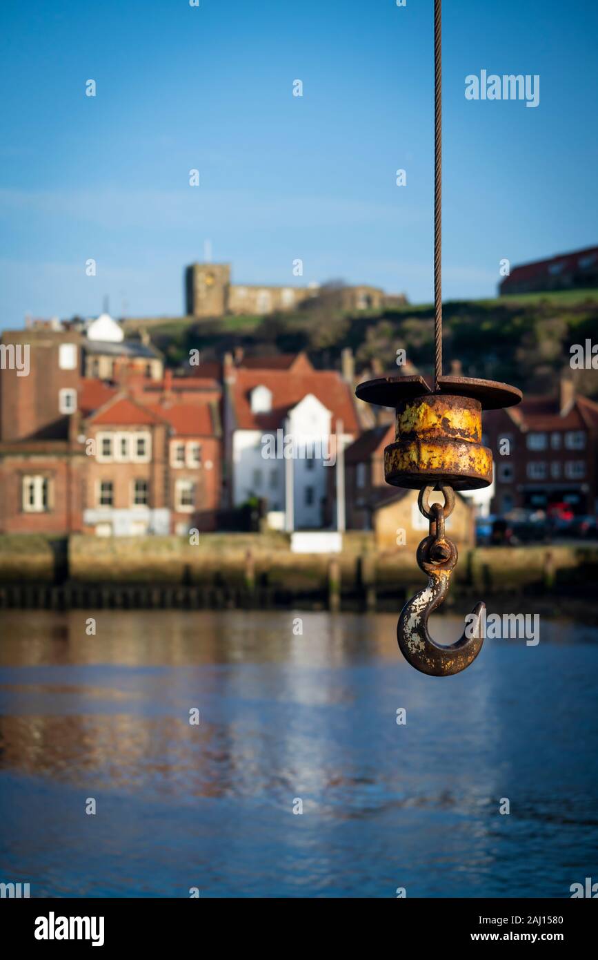 A dock side crane hook and distant out of focus St Mary's Church on the ...