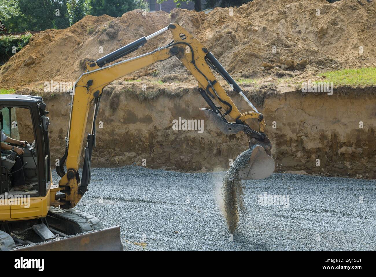 Excavator with bucket standing on gravel stones for construction of ...