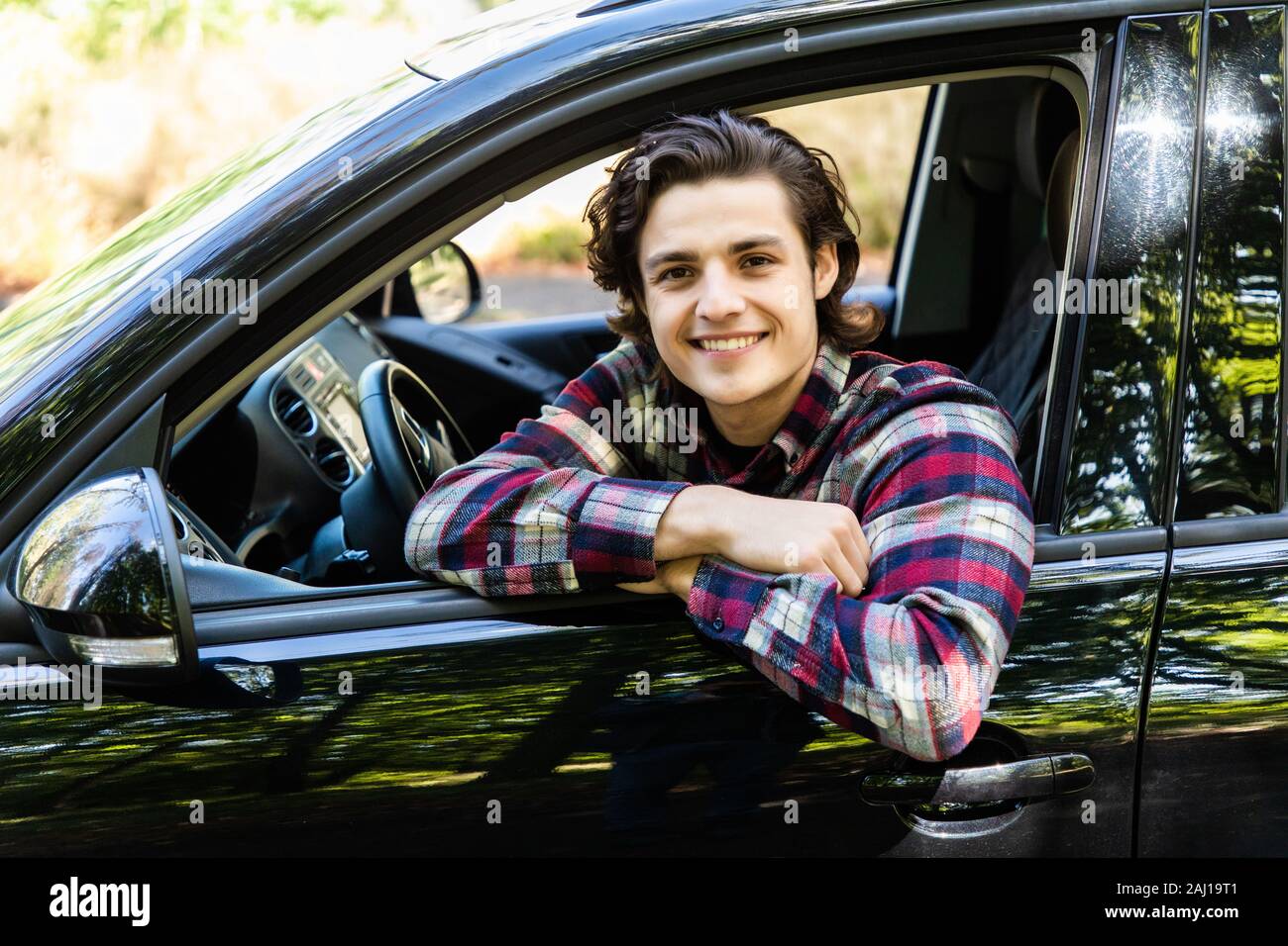 Portrait of an handsome guy driving his car Stock Photo - Alamy