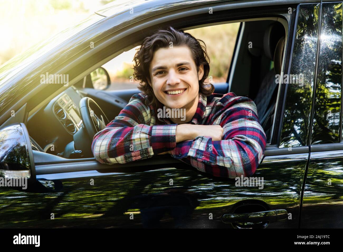Portrait of an handsome guy driving his car Stock Photo - Alamy