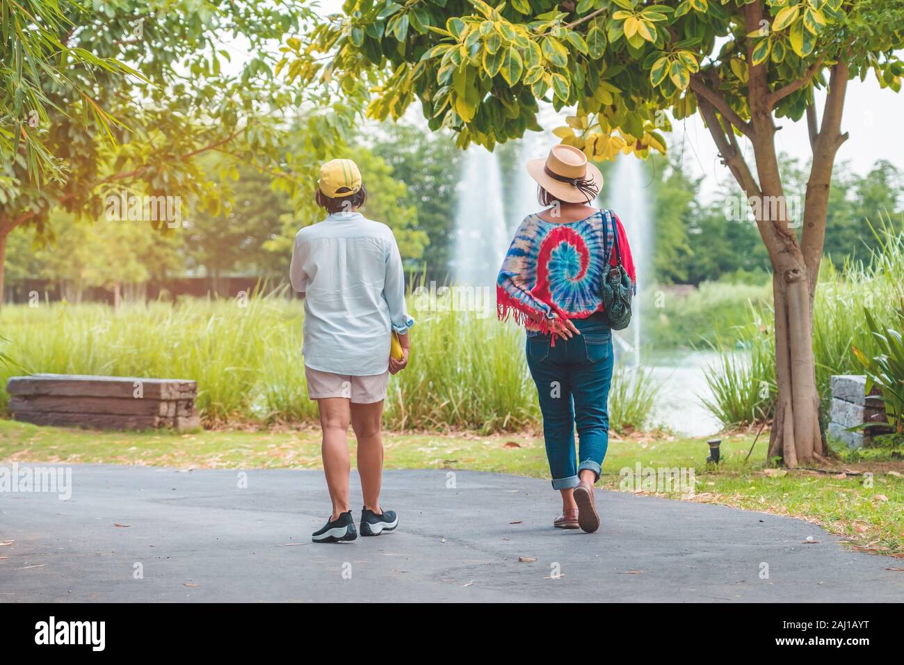 Back view of happiness female friends walking together beside the ...