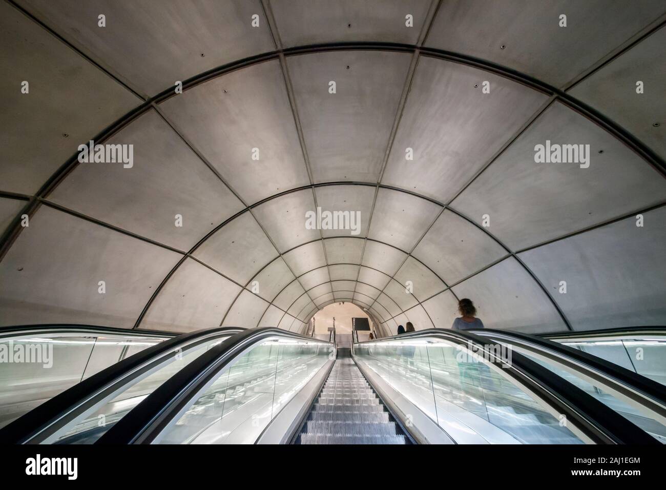 Escalators for access to a metro station with a curved roof Stock Photo ...