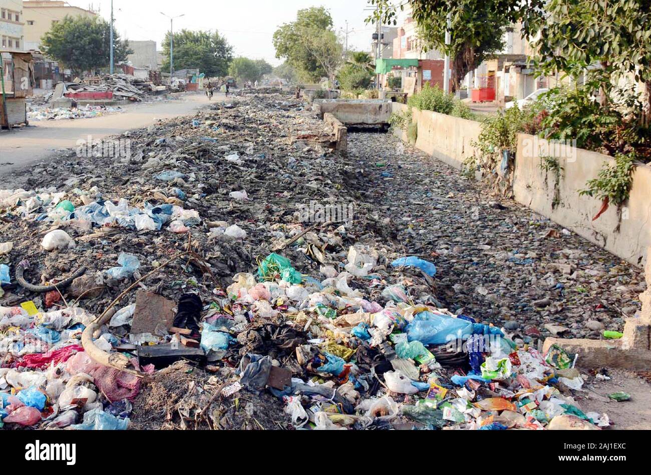 Heap of garbage covered sewerage drain causing blockage of sewerage ...