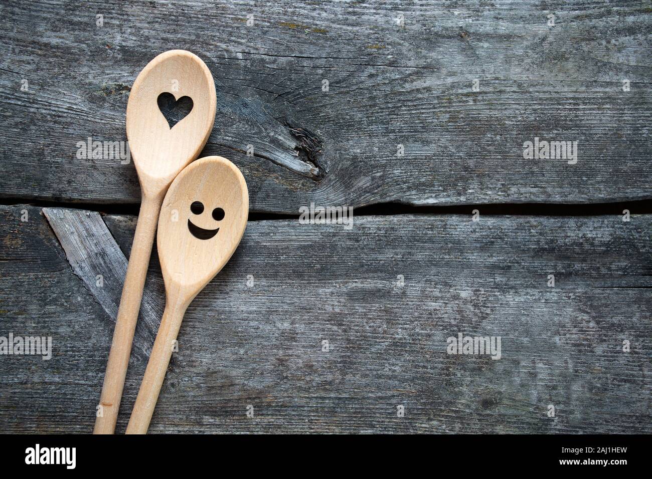 smiling wooden spoons on kitchen table Stock Photo - Alamy