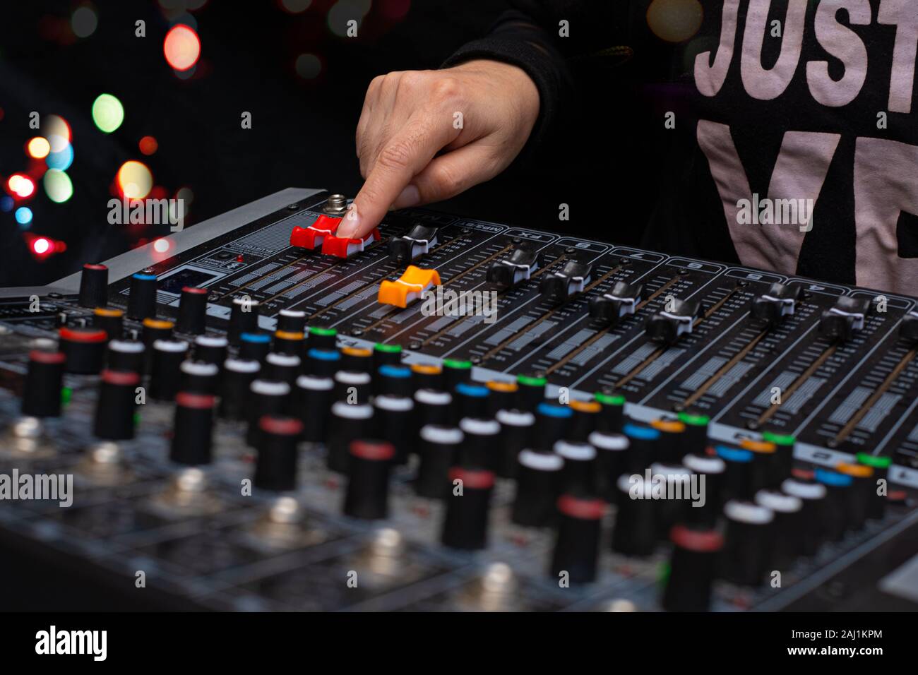 Woman hands mixing audio by sound mixer analog in the recording studio ...