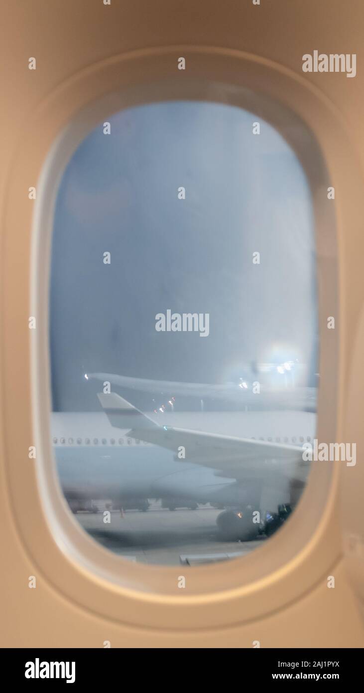 Airplanes at airport through plane window Stock Photo - Alamy