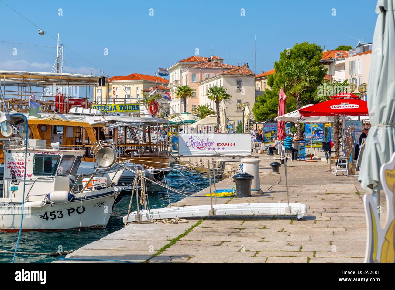 View of boats and buildings in the harbour of the Old Town of Porec and ...
