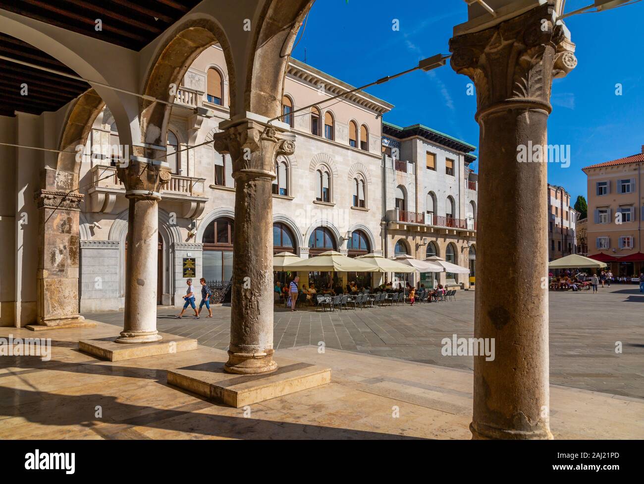 View of cafes from arches of the Town Hall in Forum Square, Pula ...