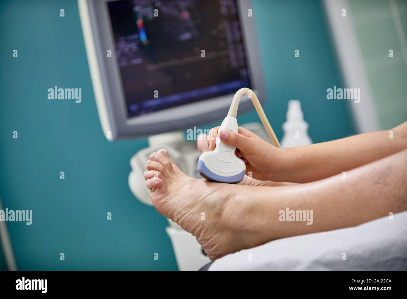 Medical Doctor with the Ultrasonography Device in a Hand checkst foot ...