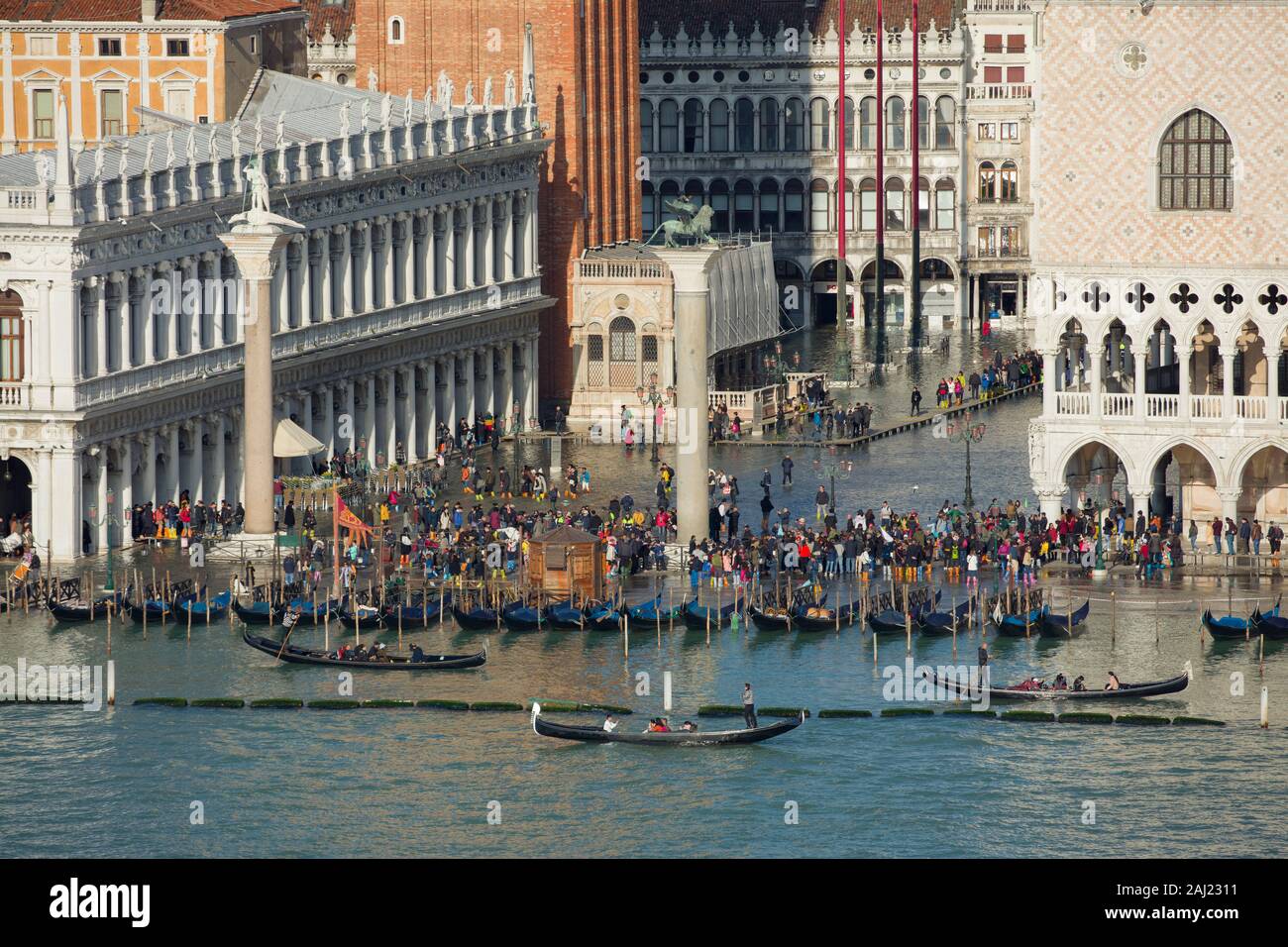 Elevated view of a busy St. Mark's Square in Venice during high tide ...