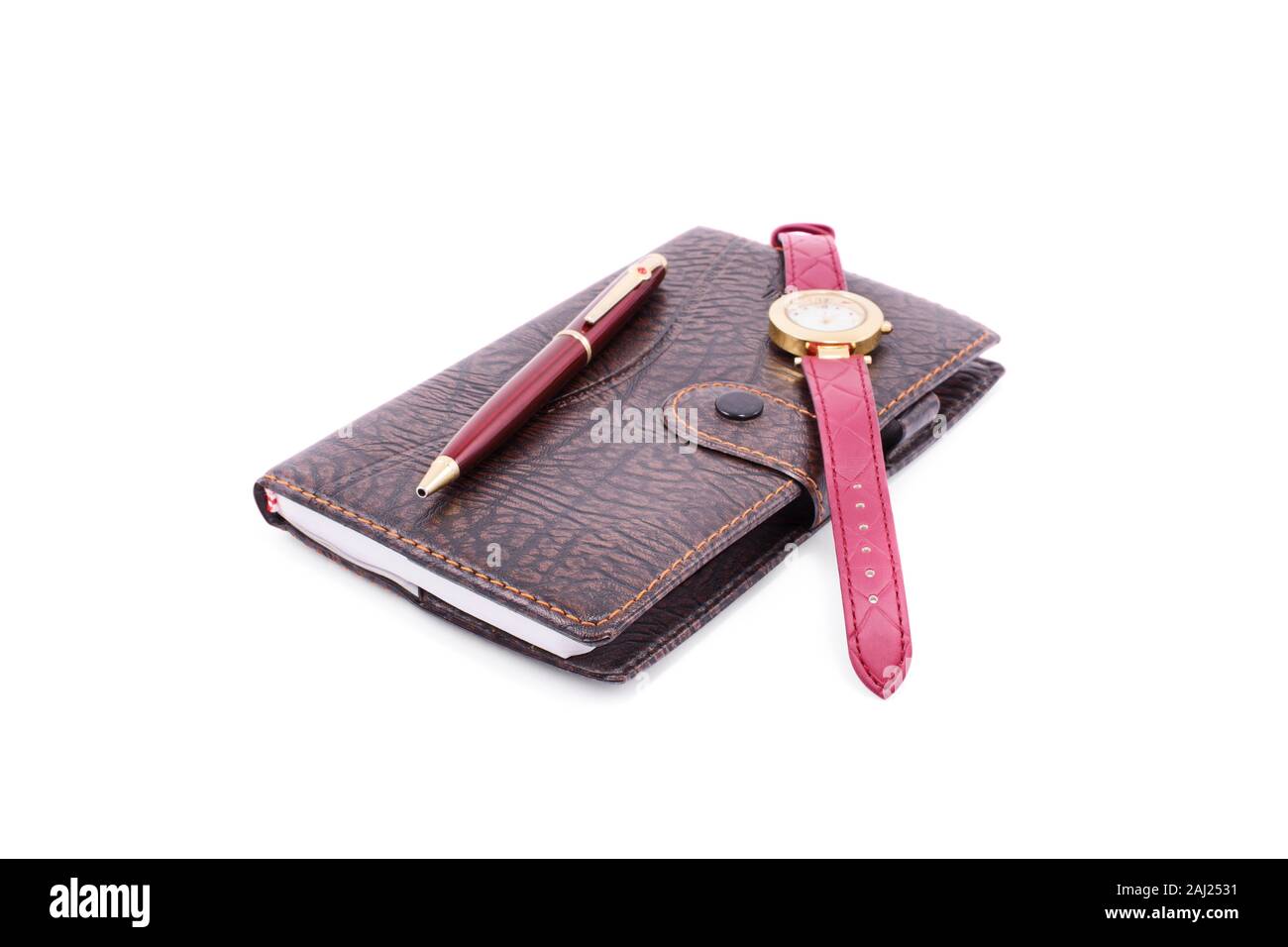Close up of a planner notebook with a pen and wrist watch, isolated on ...