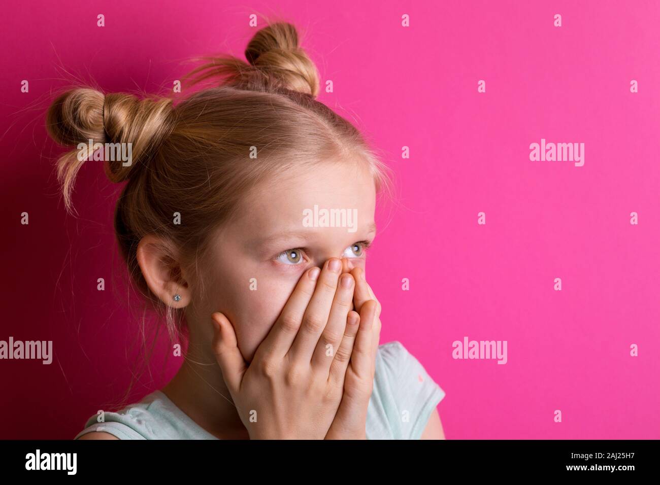little scared girl on a pink background. emotions Stock Photo - Alamy