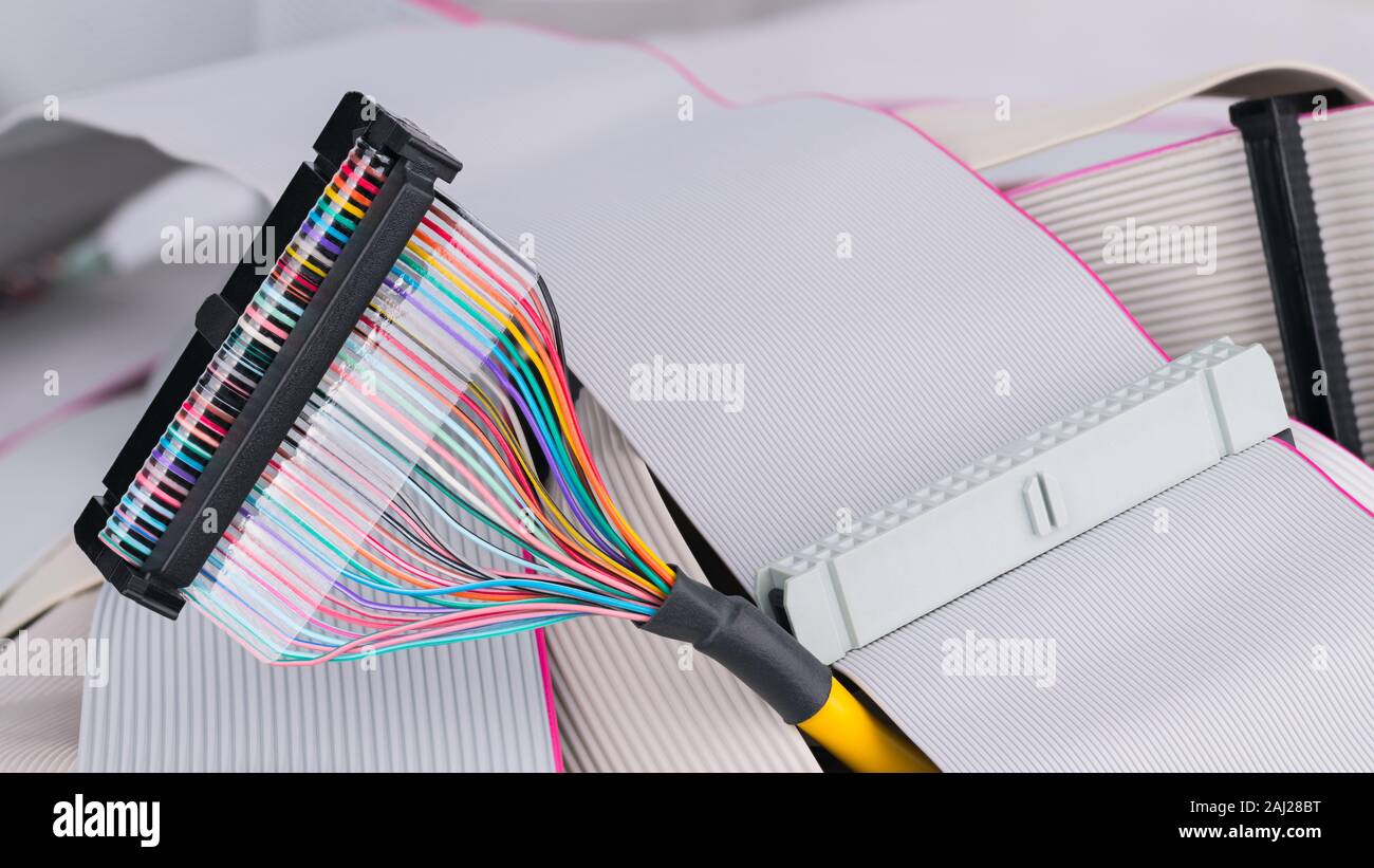 Colorful multi wire bus connector on white ribbon cables background ...