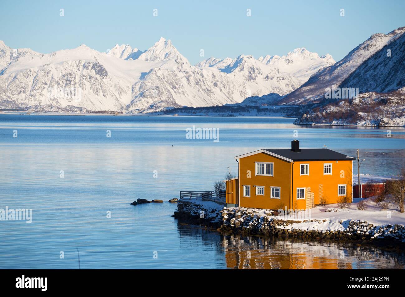 traditional norwegian yellow wooden house to stand at the lakeside and ...