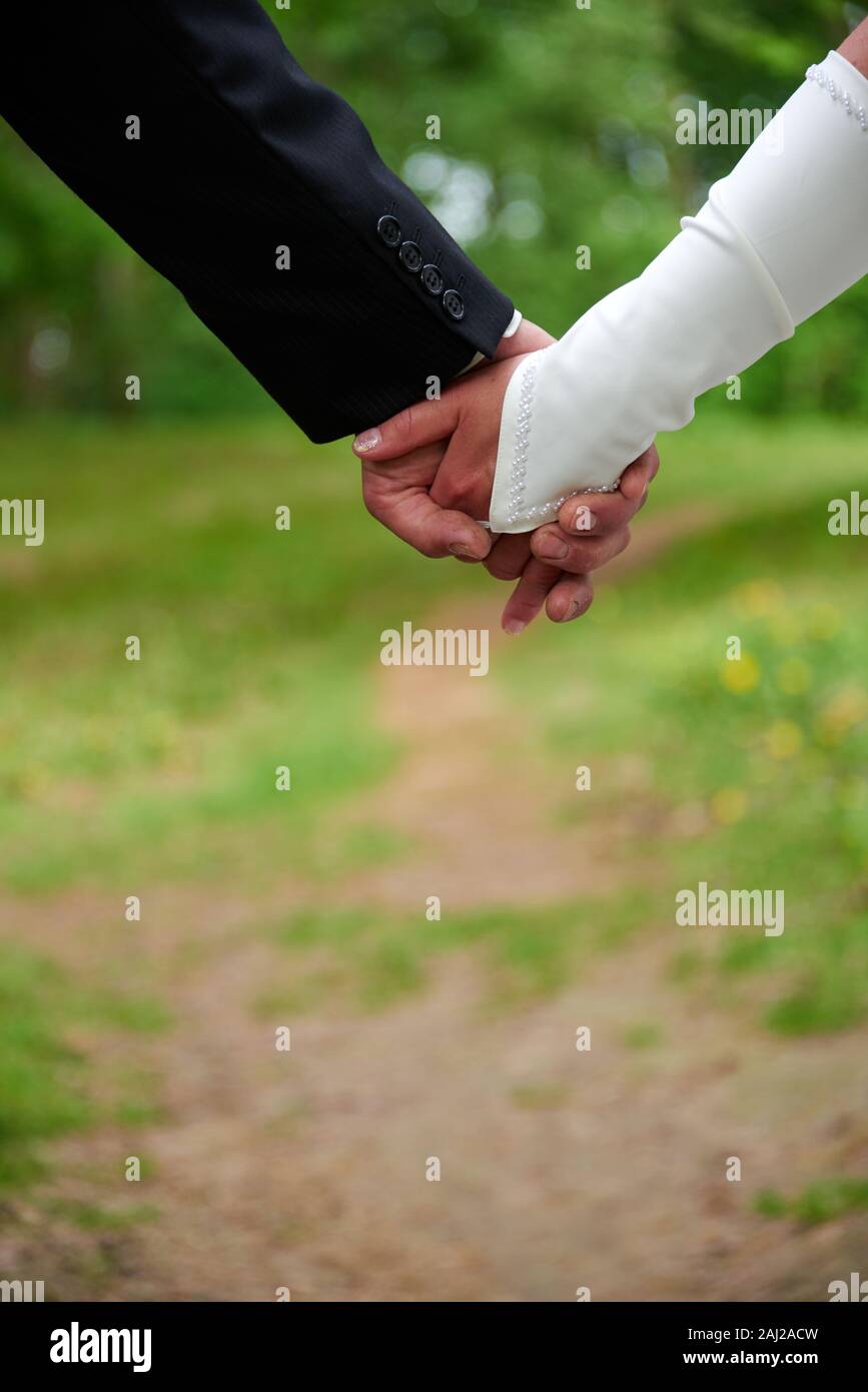 wedding couple hand in hand Stock Photo - Alamy