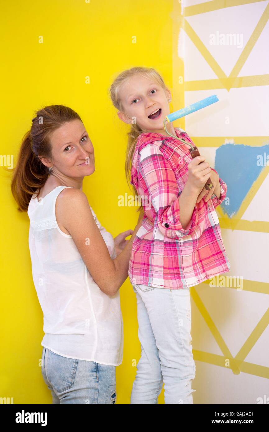 Interior Design. mom and daughter paints the wall in geometric pattern ...
