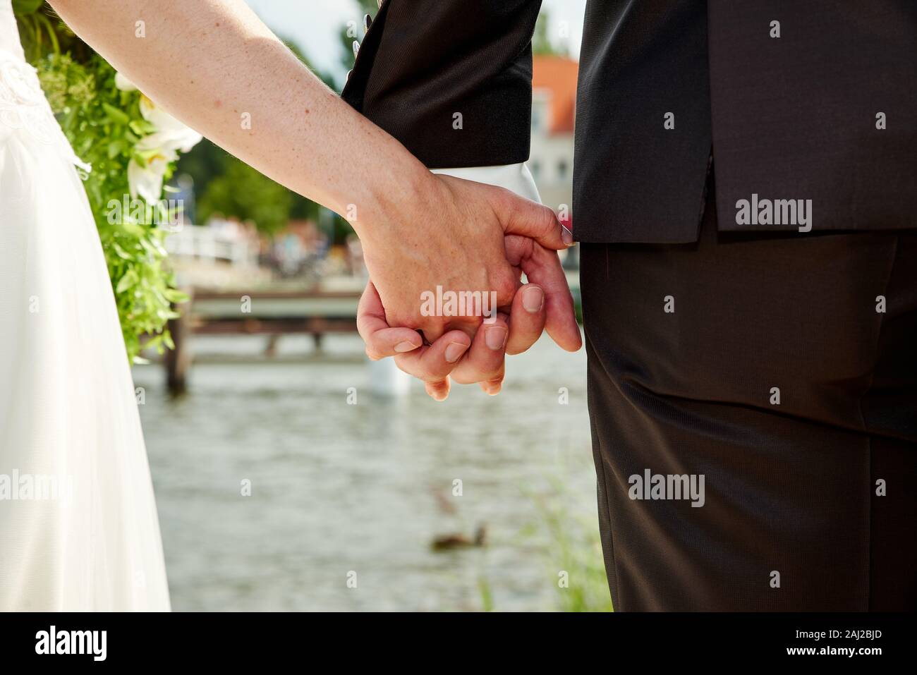 wedding couple hand in hand Stock Photo - Alamy