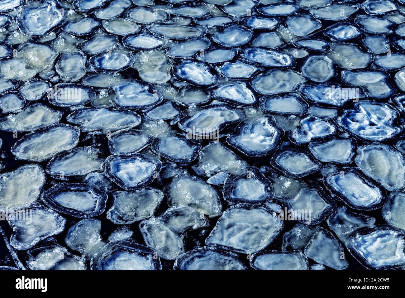 Ice on water surface in early winter Stock Photo - Alamy