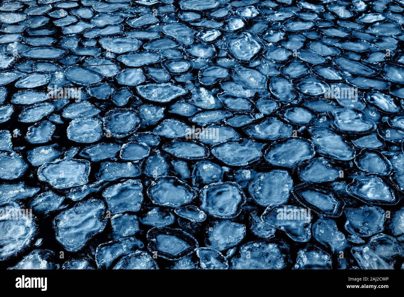 Ice on water surface in early winter Stock Photo - Alamy
