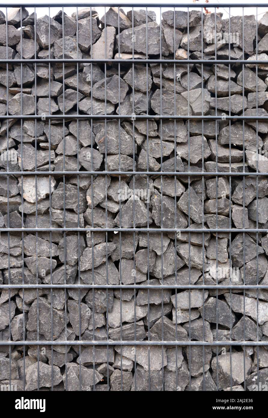 Rubble stone in steel net wall. Texture background Stock Photo - Alamy
