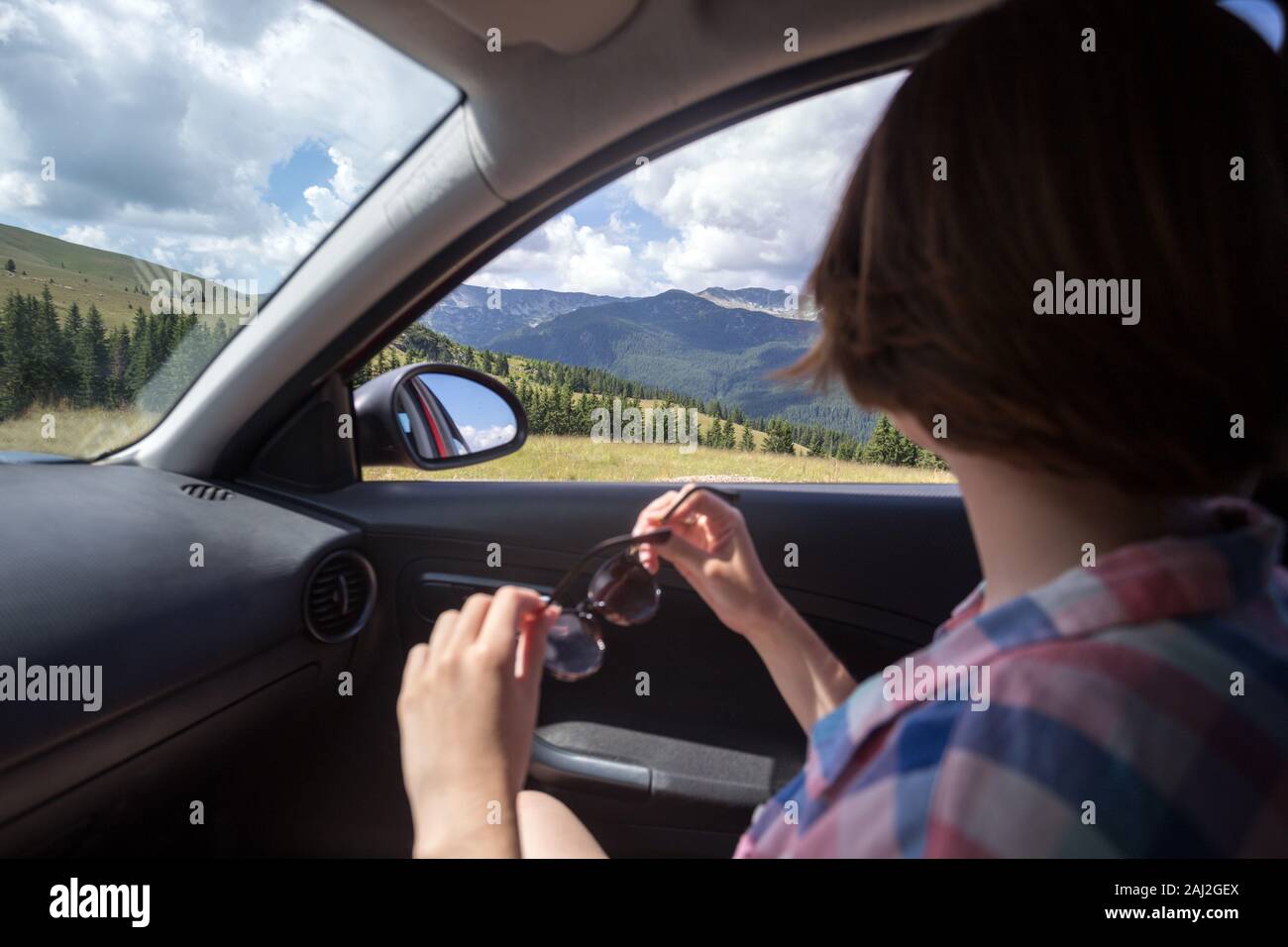 Summer Road Trip. Happy beautiful girl traveling in a car across at the ...