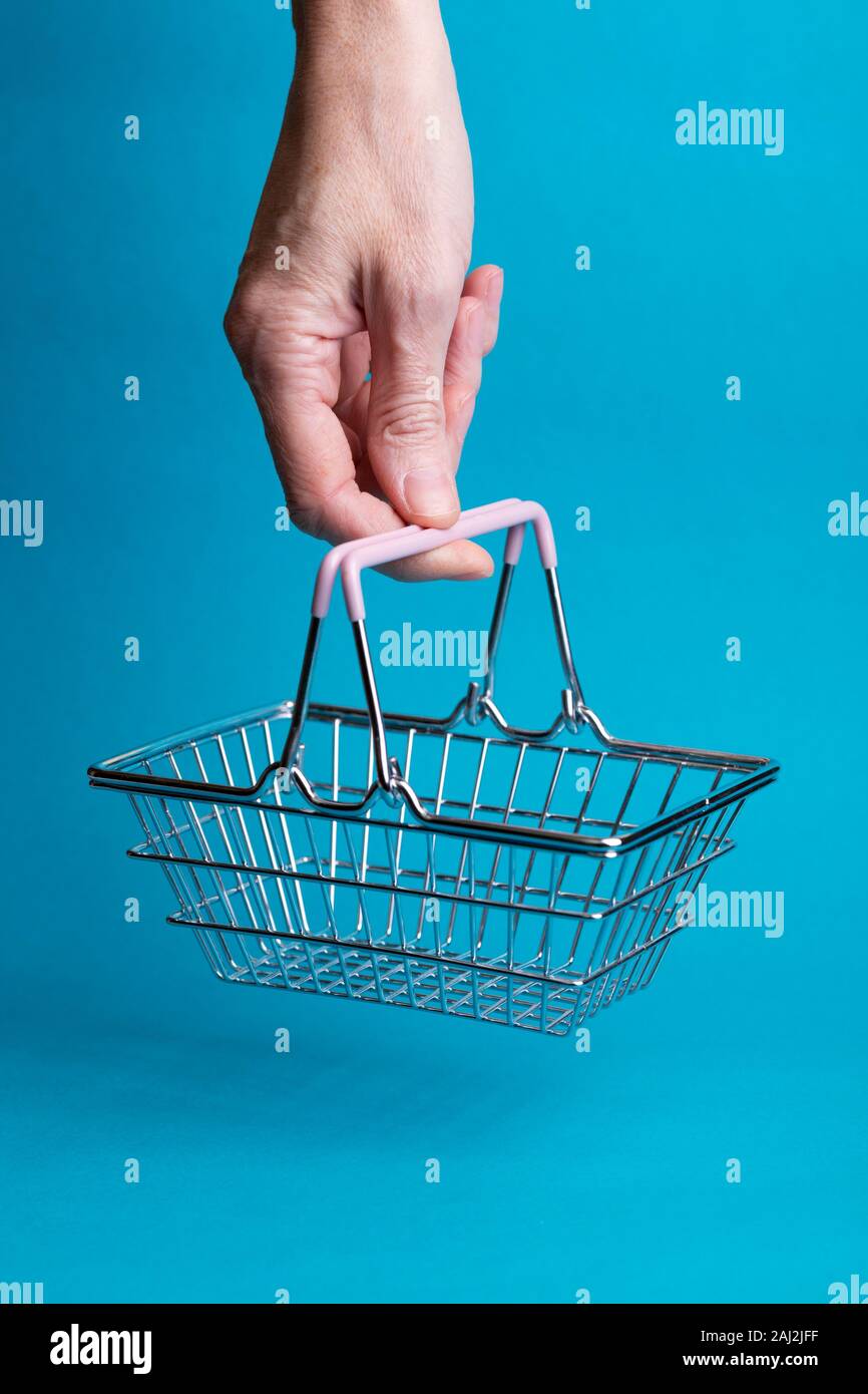 Prices for shopping consumer basket products. empty basket on a blue ...