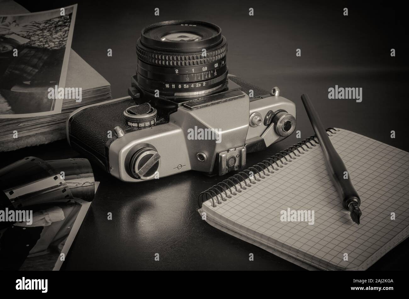 Old metal camera on a dark table. Photo album, photographs, film and ...