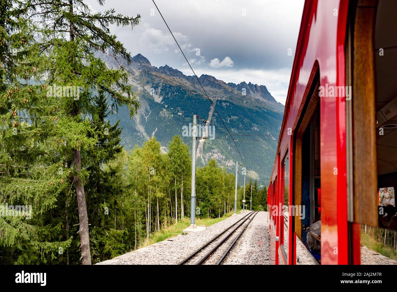 Red train in French Alps near Chamonix Stock Photo - Alamy
