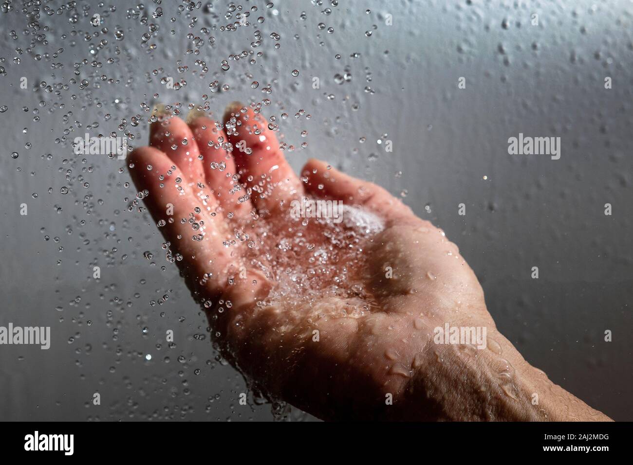 Human hand and falling water drops Stock Photo - Alamy