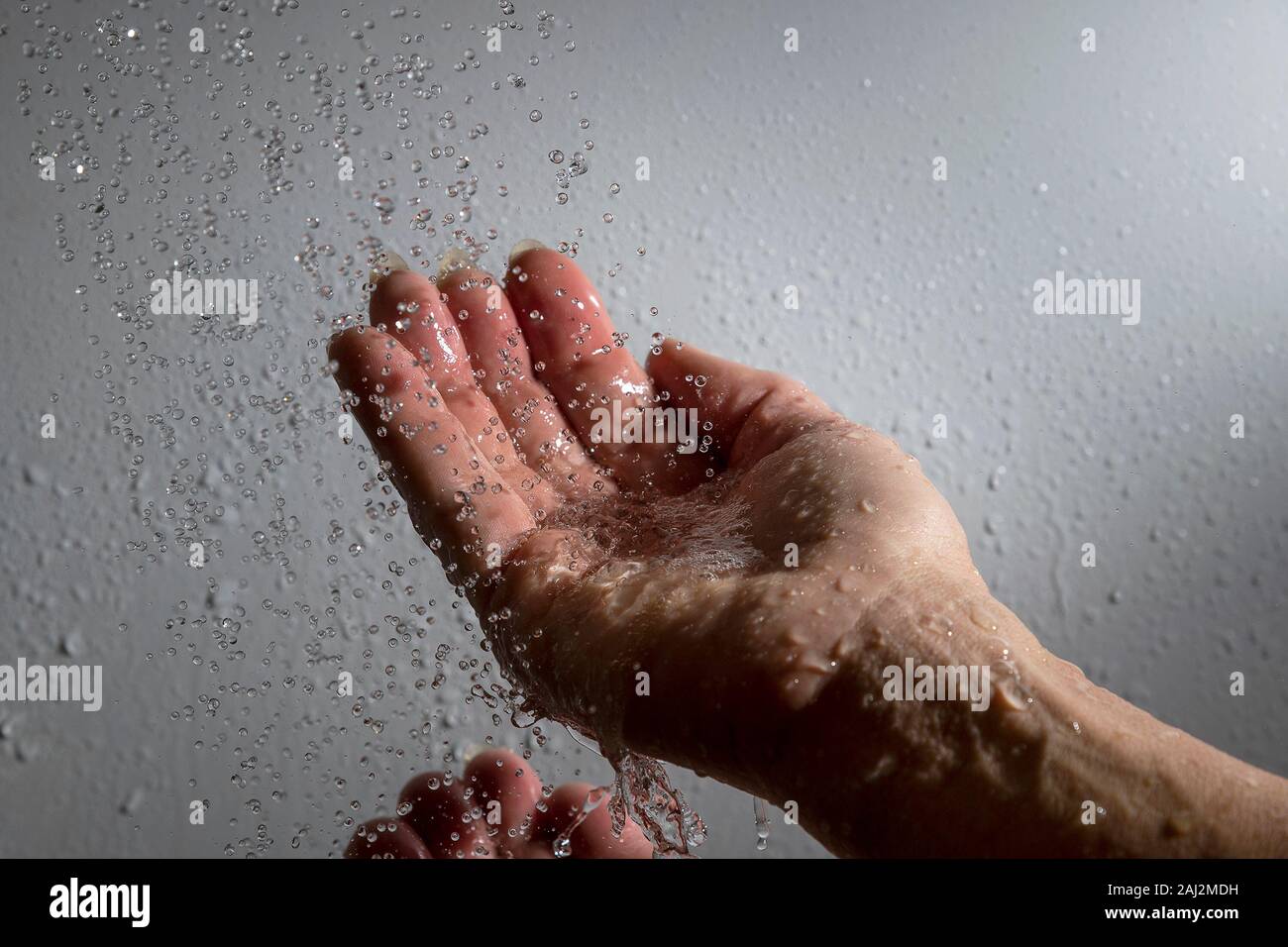 Human hand and falling water drops Stock Photo - Alamy