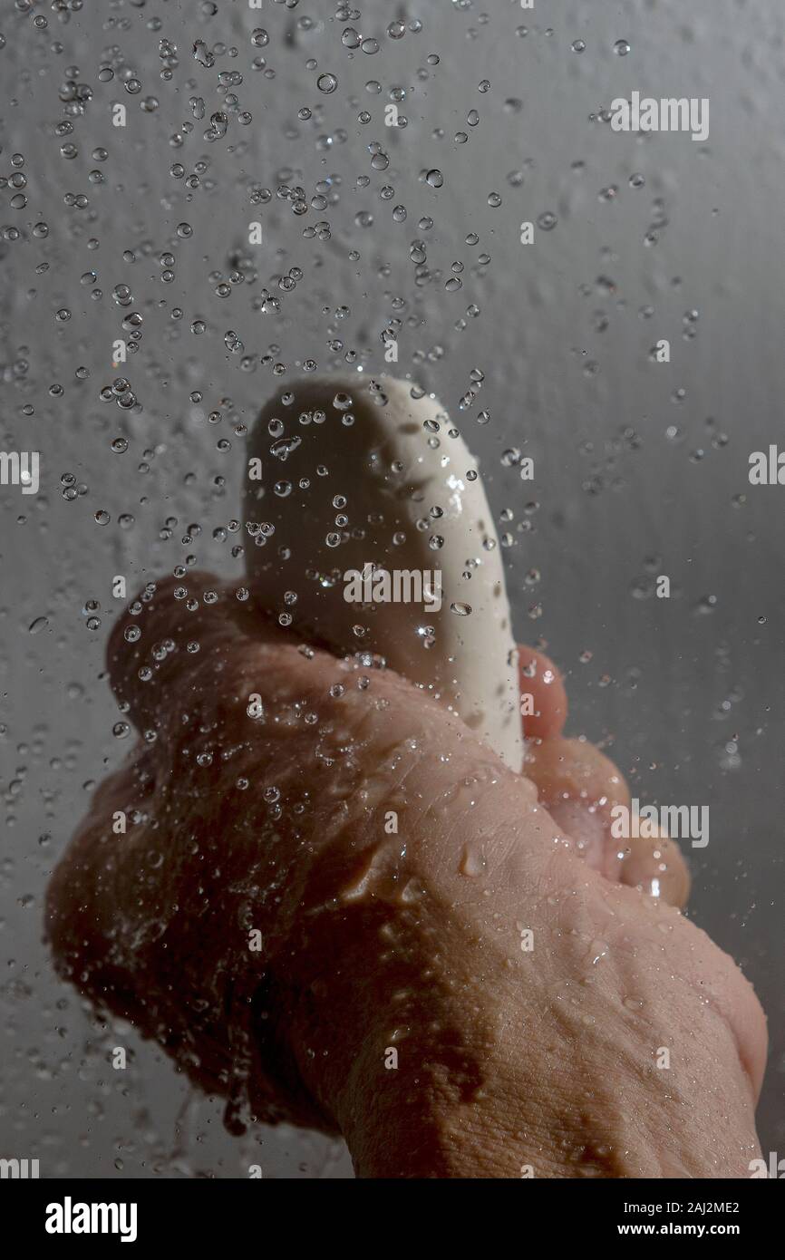 Soap in human hands and falling water Stock Photo - Alamy