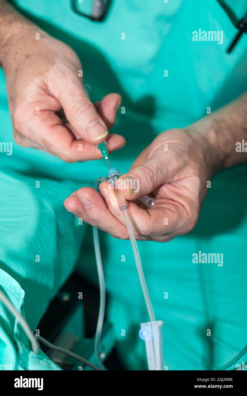 Surgical team preparing their patient for surgery, anesthesiologist ...
