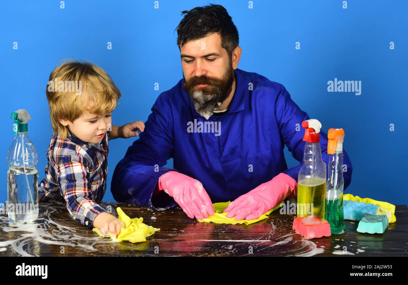 Child and father cleaning table together. Family time concept. Dad with ...