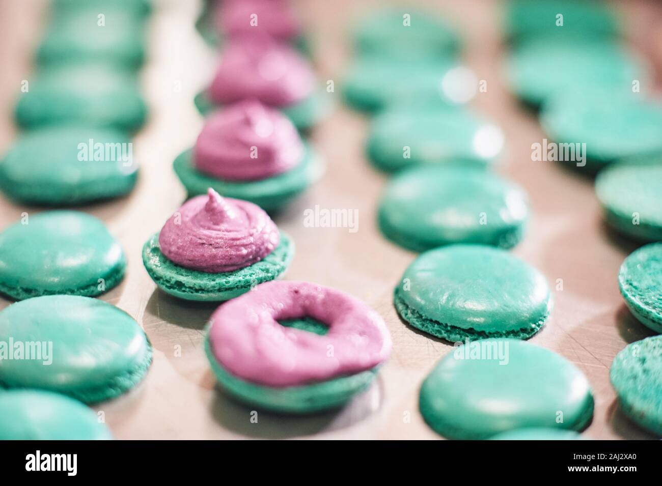 macaroons shells in a tray. Process of making macaron, french dessert ...