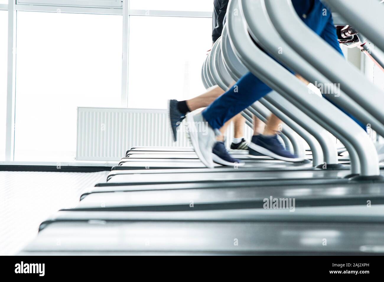 gym shot - people running on machines, treadmill with motion blur Stock ...