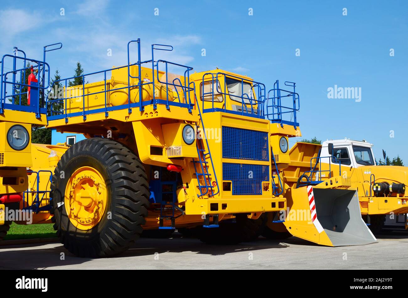 Heavy-duty trucks warehouse at autoworks. Giant mining dump trucks ...