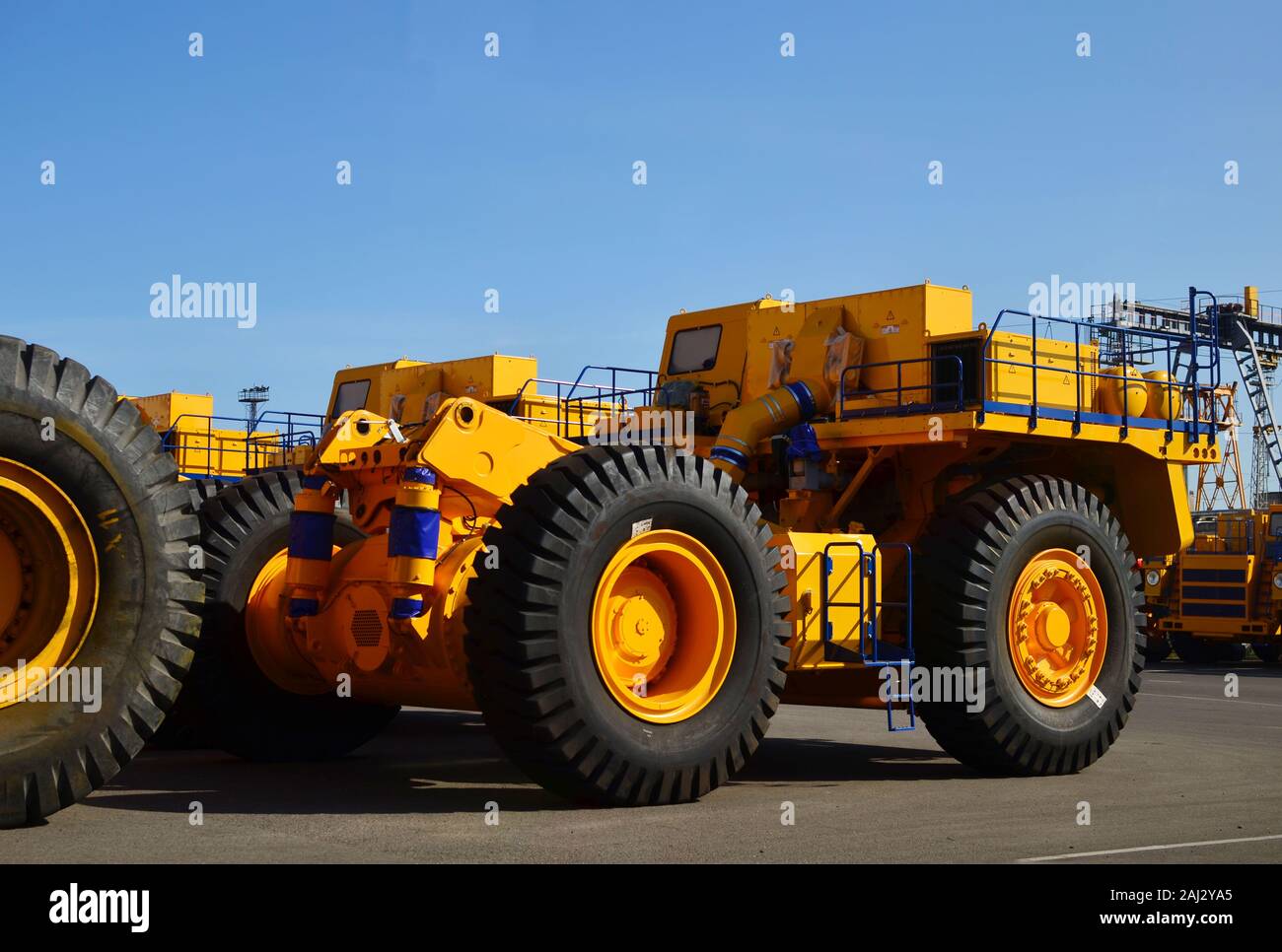 Heavy-duty trucks warehouse at autoworks. Giant mining dump trucks ...