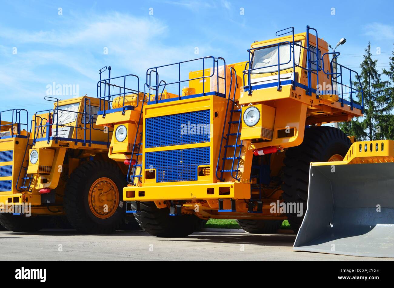 Heavy-duty trucks warehouse at autoworks. Giant mining dump trucks ...