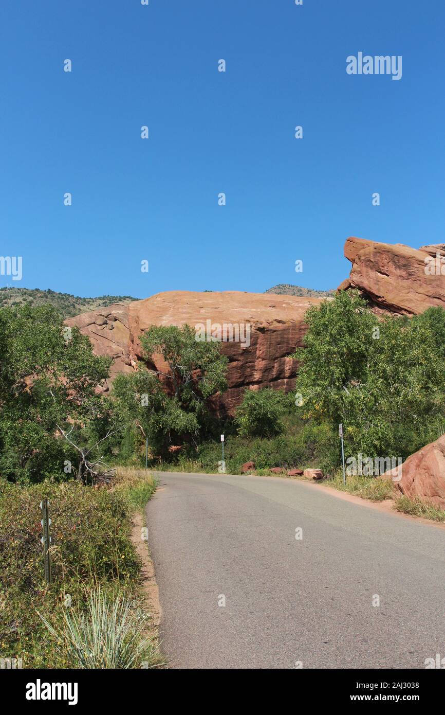 Red Rock Loop Road lined with large, red rock formations, trees and ...